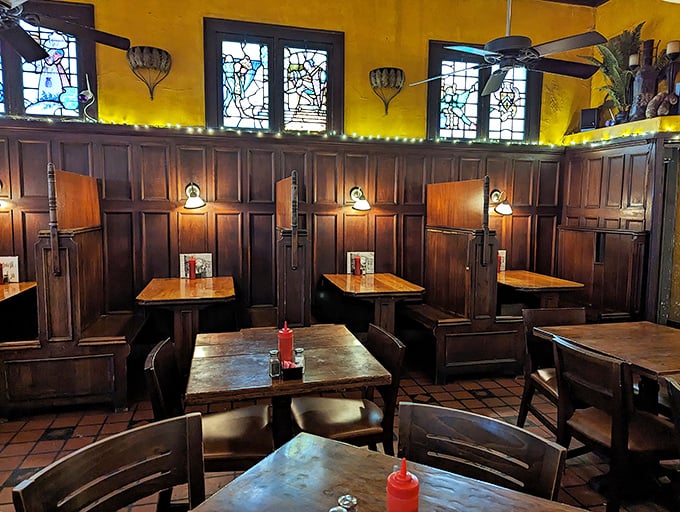 Church-like stained glass meets boxing memorabilia in this warm wooden sanctuary. The high-backed booths aren't just seating—they're ringside seats to culinary magic.
