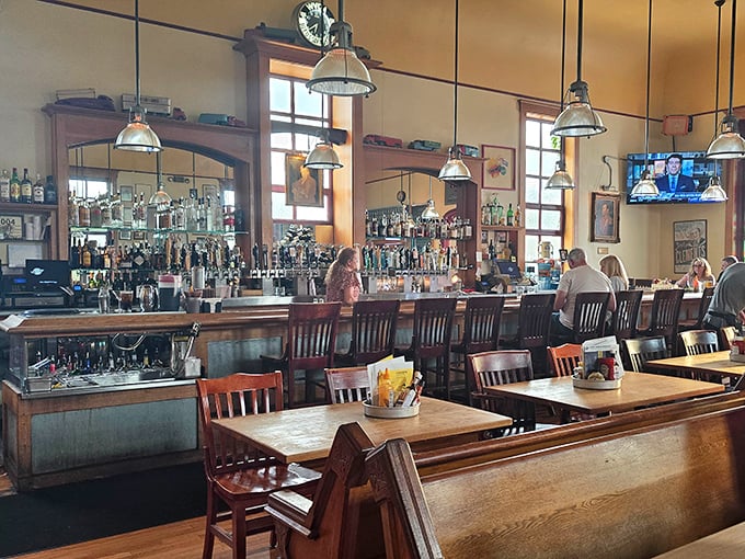 Industrial pendant lights cast the perfect golden glow over conversations destined to become legendary dining memories.