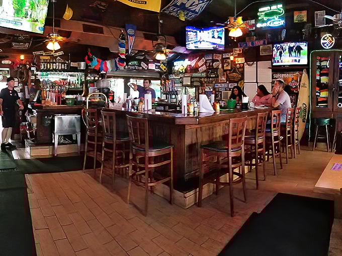 Where license plates meet surfboards and cold drinks. This isn't interior decorating—it's a museum of good times with barstools.