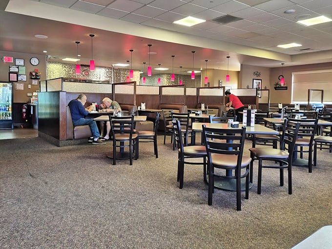 Inside, pink pendant lights cast a warm glow over comfortable booths where regulars have claimed their spots for years of memorable meals.