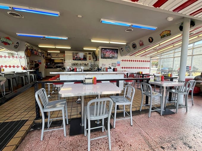 Classic diner aesthetics meet modern comfort inside, where every seat promises a front-row view to burger perfection.