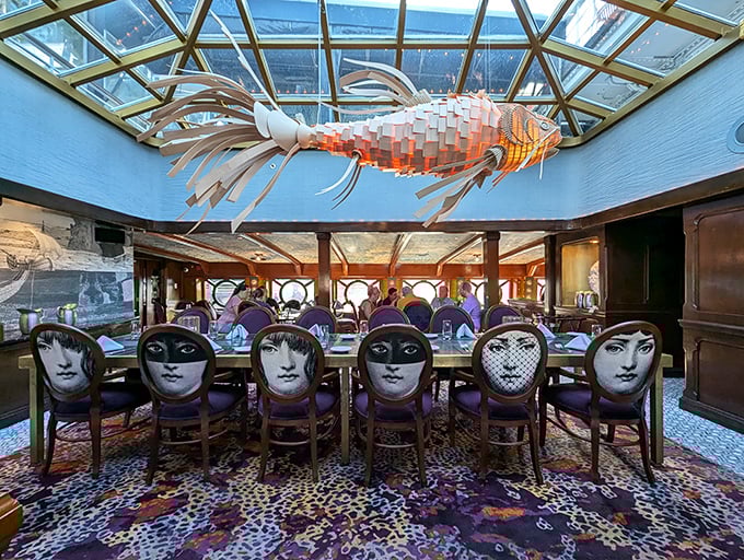 Dining under a sculptural fish that seems to swim through the glass ceiling—this isn't just dinner, it's theater with a side of seafood.