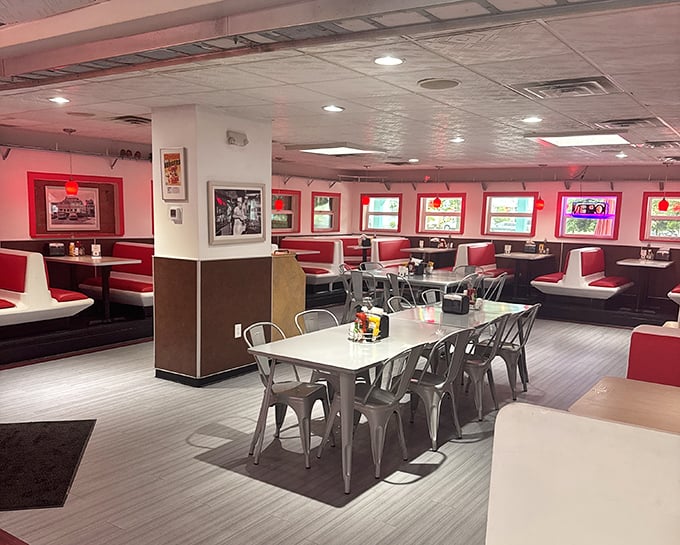 Red vinyl booths and retro charm create the perfect backdrop for burger bliss – where conversations flow as freely as the milkshakes.