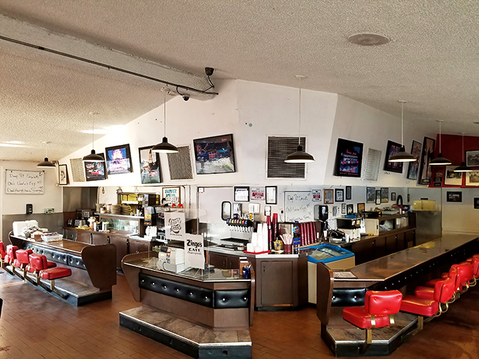 The horseshoe counter with its cherry-red vinyl stools isn't just seating—it's front-row tickets to the greatest breakfast show in Bakersfield.