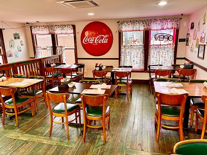 Wooden chairs, vintage Coca-Cola signs, and checkered curtains – this isn't manufactured nostalgia, folks. It's the real deal that chain restaurants spend millions trying to replicate.