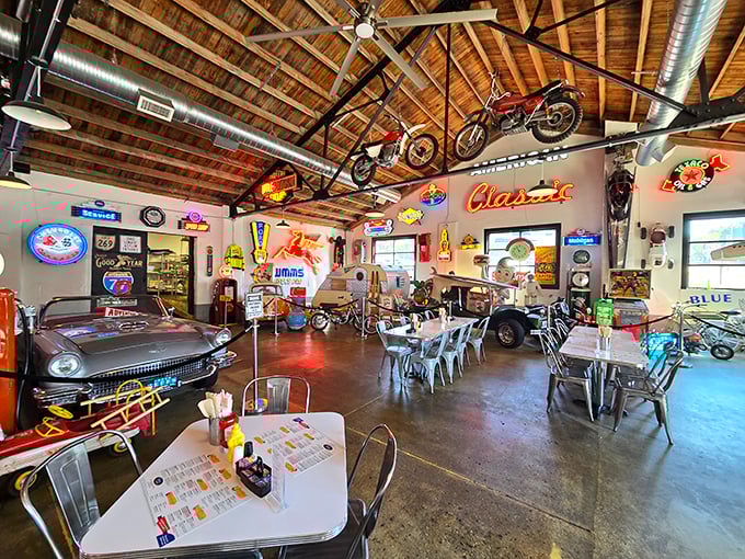 Vintage motorcycles suspended from wooden rafters and classic cars parked indoors? This isn't just a diner—it's an automotive museum that happens to serve incredible food.
