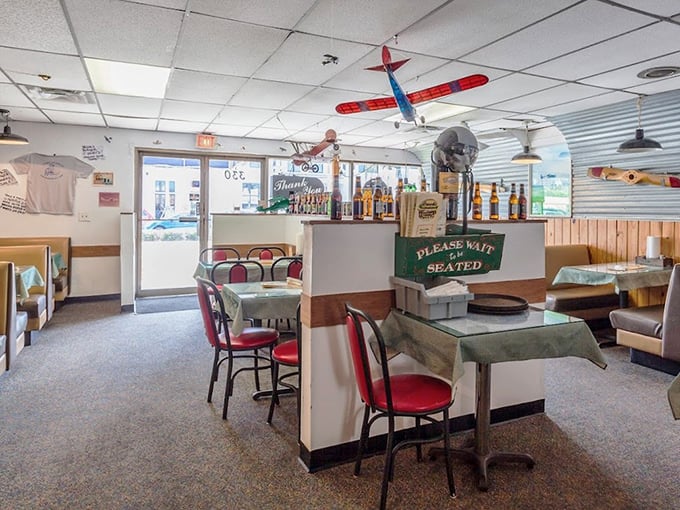 Model airplanes soar above diners, creating a whimsical atmosphere that says, "We're serious about burgers, not about being serious."