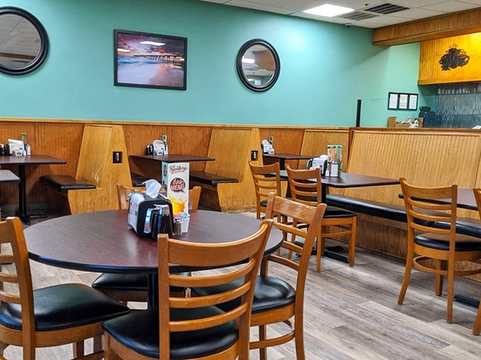 Coastal cool meets breakfast comfort inside with aqua walls, wooden booths, and just enough nautical touches to remind you you're at the beach.