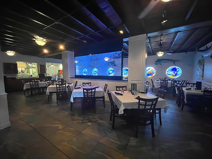 Inside, the mood shifts from beachy blue to sophisticated dining sanctuary, where stained glass marine life watches over your meal like aquatic guardian angels.