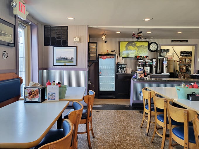 Step inside to a world where aviation memorabilia meets comfort food paradise. The corrugated metal wainscoting isn't trying to impress Architectural Digest—it's too busy supporting delicious meals.