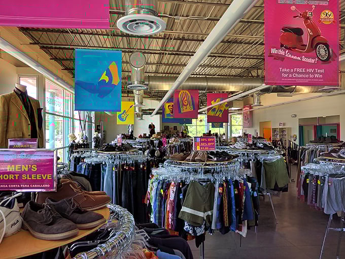 Treasure hunting begins here, where colorful banners hang like festival flags above a sea of carefully organized clothing racks waiting to be explored.