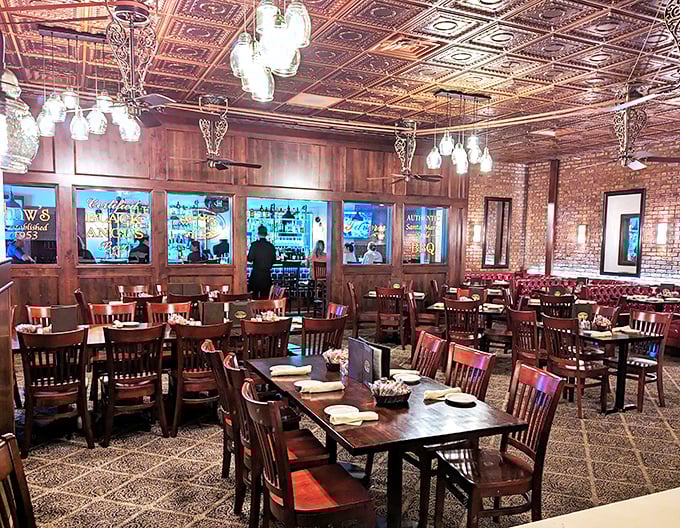 Pressed tin ceilings, warm wood paneling, and brick walls create the holy trinity of steakhouse ambiance. This isn't decoration—it's a time machine to when dining meant something.