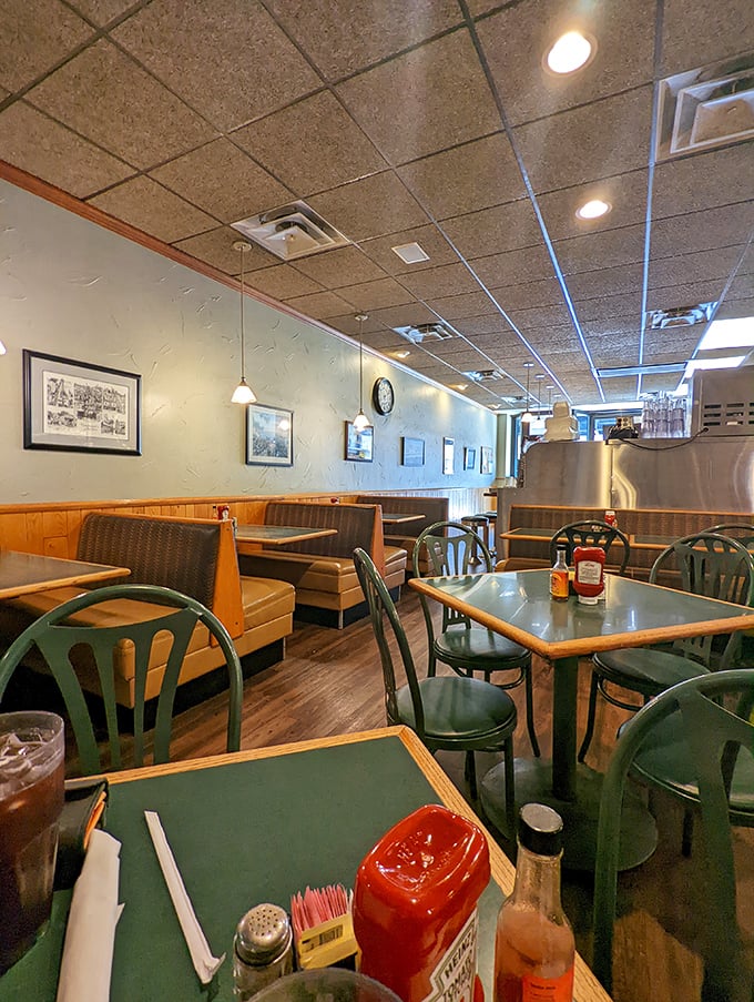 Classic green vinyl chairs and wood-paneled walls tell you immediately: this isn't retro by design, it's authentic by choice.