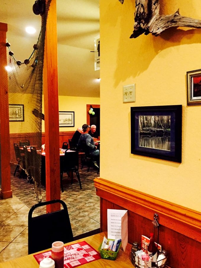Yellow walls adorned with fishing nets and coastal artwork create the perfect backdrop for seafood that's about to steal the show.