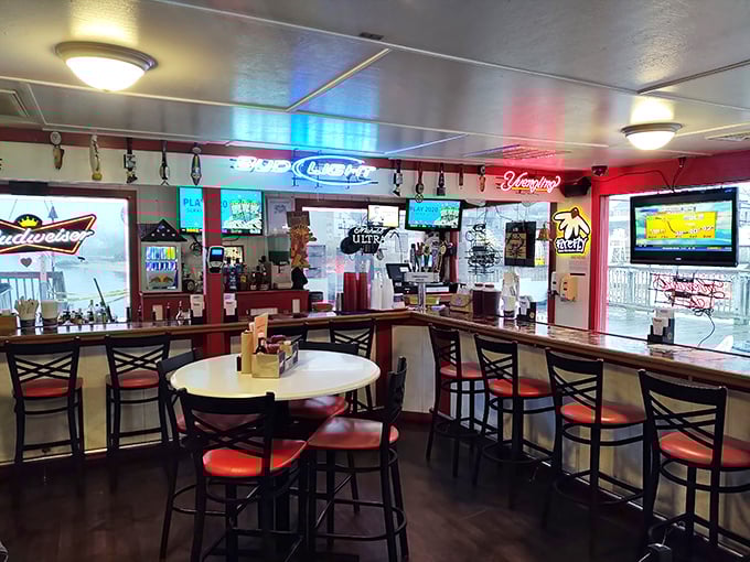 Where everybody knows your name – or will by dessert. The bar's neon glow and cozy seating invite lingering conversations over cold drinks.