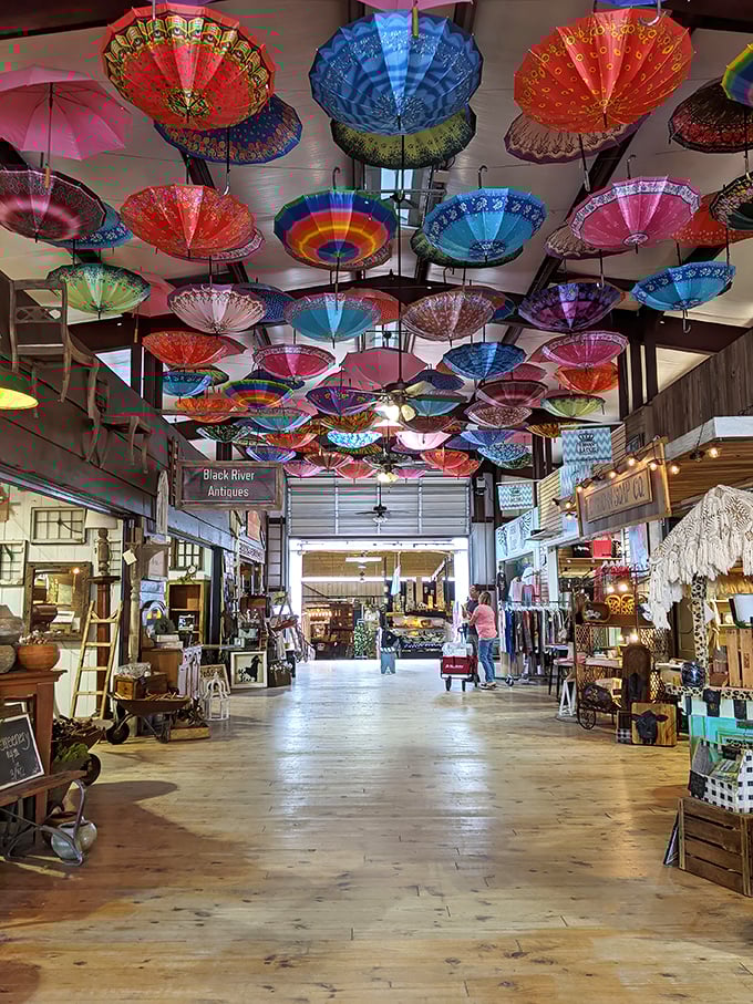 A ceiling adorned with colorful parasols creates an Alice in Wonderland vibe, transforming shopping into a whimsical adventure.