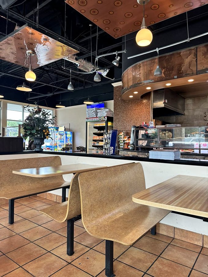 Modern industrial meets cozy comfort inside. Those copper ceiling panels add unexpected flair to a space that prioritizes what matters—the food.