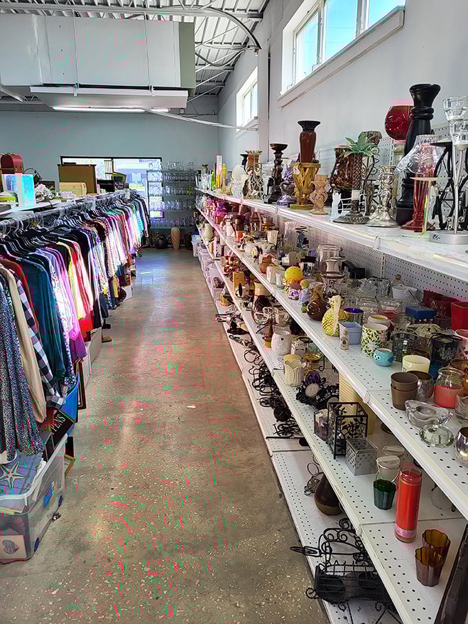 Organized chaos at its finest—clothing racks flank shelves of decorative treasures, each aisle a new adventure waiting to unfold.