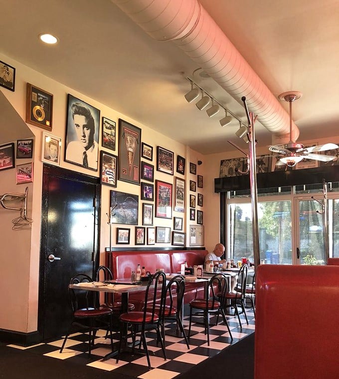 Elvis watches over diners from his place of honor on walls packed with nostalgia. The red vinyl booths practically beg you to slide in.