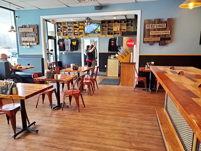 Inside, the warm wood tables and industrial metal chairs create that perfect "come as you are" vibe where both business suits and sauce-stained t-shirts feel equally at home.