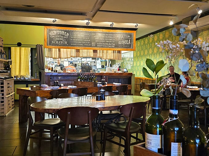 The warm interior combines green wallpaper, wooden tables, and an open kitchen—the culinary equivalent of your Italian grandmother's embrace.