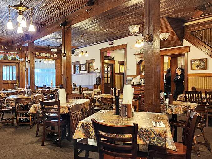Exposed wooden beams and vintage fixtures create a warm, nostalgic atmosphere that feels like dining in a beloved family cabin.