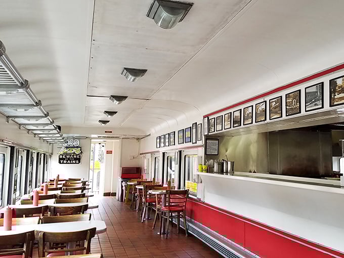 Step inside a time machine disguised as a dining car. The curved ceiling, classic counter, and red accents create a nostalgic atmosphere that's as comforting as the food.