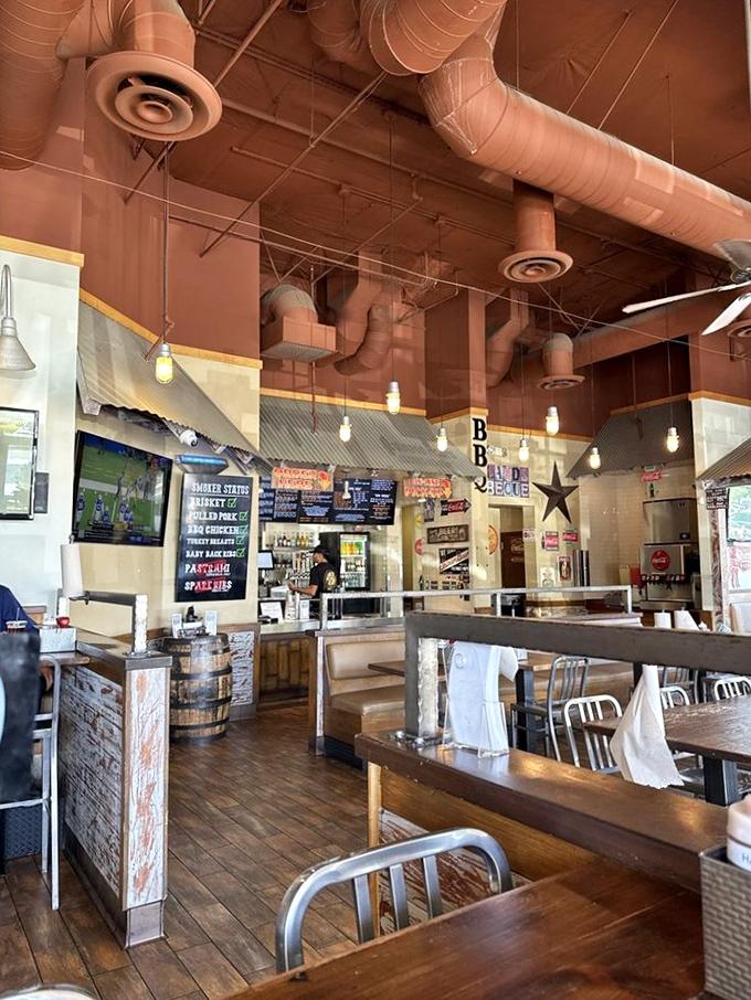 Industrial chic meets smokehouse authenticity. Those exposed ducts aren't just for show—they're carrying the intoxicating aroma of slow-smoked heaven.