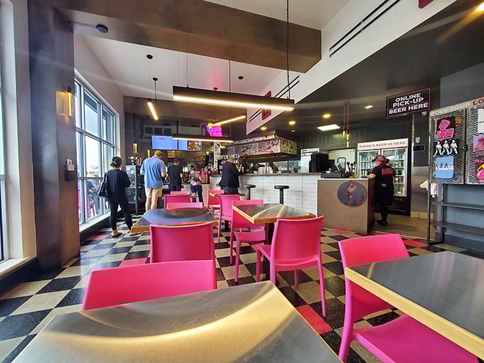 Modern meets comfort in this stylish interior where hot pink chairs aren't just a design choice—they're fair warning about the heat levels ahead.