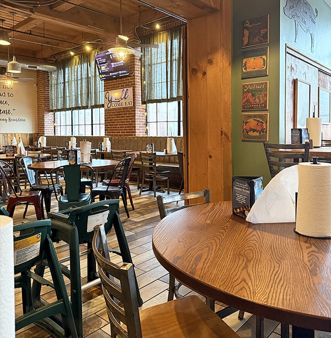 Rustic wooden tables, exposed beams, and natural light create the perfect backdrop for the serious business of barbecue appreciation.