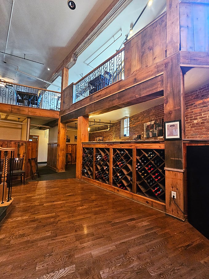 Rustic meets refined in this two-story dining space where exposed brick, wooden beams, and an impressive wine display create the perfect backdrop for culinary magic.