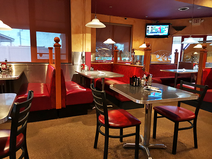 Red vinyl booths and warm lighting create the perfect stage for morning conversations and coffee refills.