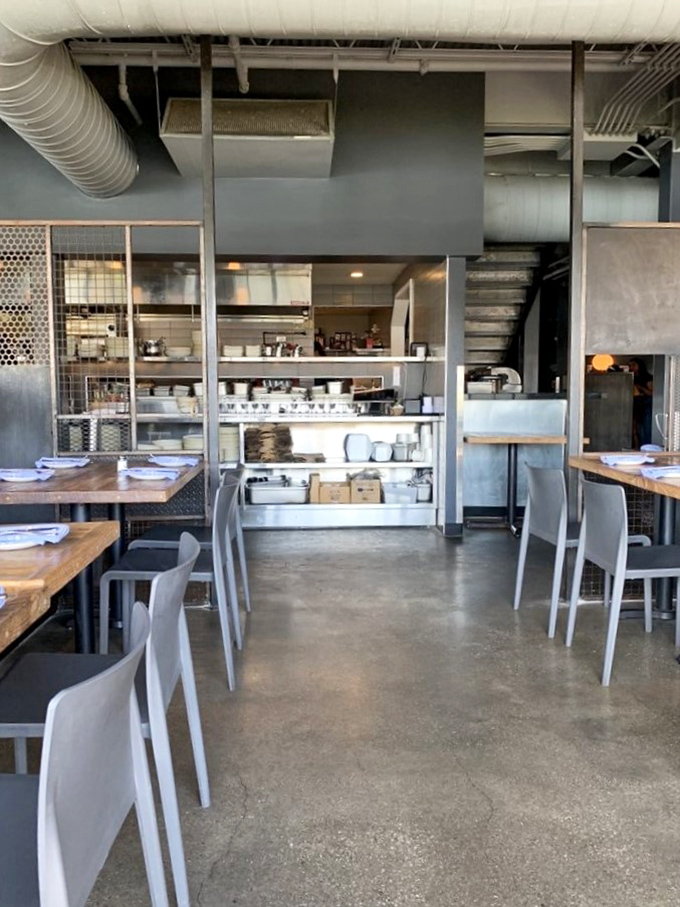 Inside, concrete floors meet wooden tables in a space where exposed ductwork isn't industrial—it's jewelry. This isn't decoration; it's Cleveland's soul made visible.