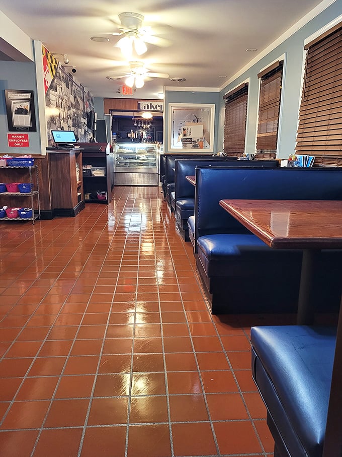 Classic navy booths, gleaming terra cotta floors, and ceiling fans spinning lazily overhead—Marie's interior feels like stepping into a Norman Rockwell painting that serves incredible food.