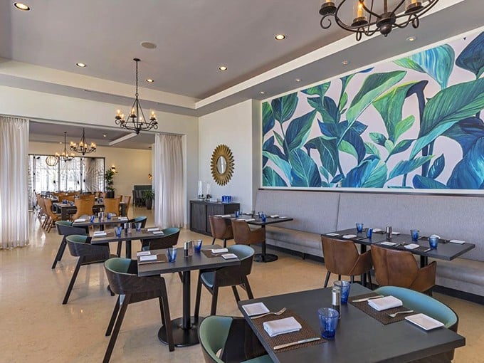 Mid-century modern meets coastal chic inside SHOR, where that stunning tropical leaf mural isn't competing with the views—it's complementing them.