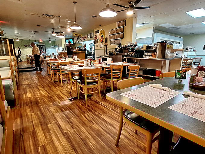 Inside, warm wood floors and simple furnishings create that perfect diner atmosphere where conversations flow as freely as the coffee.
