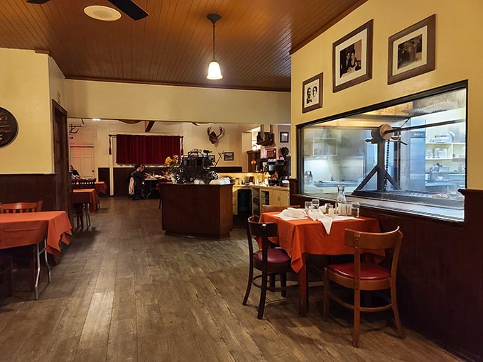 Step inside and you're transported to a simpler time—wooden ceilings, orange tablecloths, and a window to watch culinary artistry in action.
