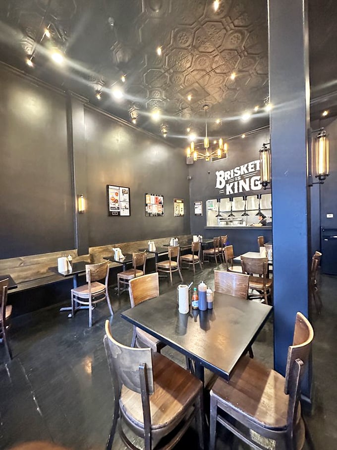 Industrial-chic meets barbecue tradition under that gorgeous pressed tin ceiling. The "Brisket King" sign isn't just decoration—it's truth in advertising.