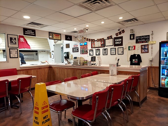 Classic red vinyl chairs and wood paneling create the perfect time capsule. This isn't retro by design—it's authentic by persistence.