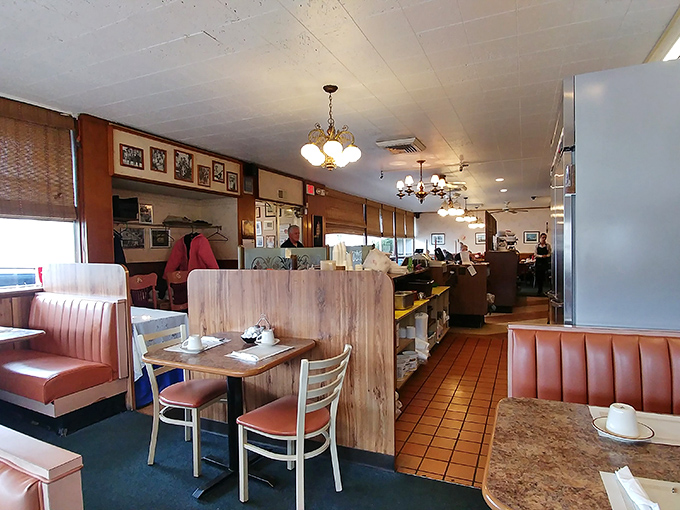 Classic diner aesthetics at their finest—salmon-colored booths, wooden dividers, and lighting that makes everyone look like they've just returned from vacation.