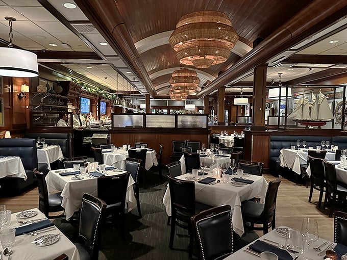 Step inside and you're transported to a maritime dream—rich wood paneling, white tablecloths, and chandeliers that would make Neptune himself feel at home.