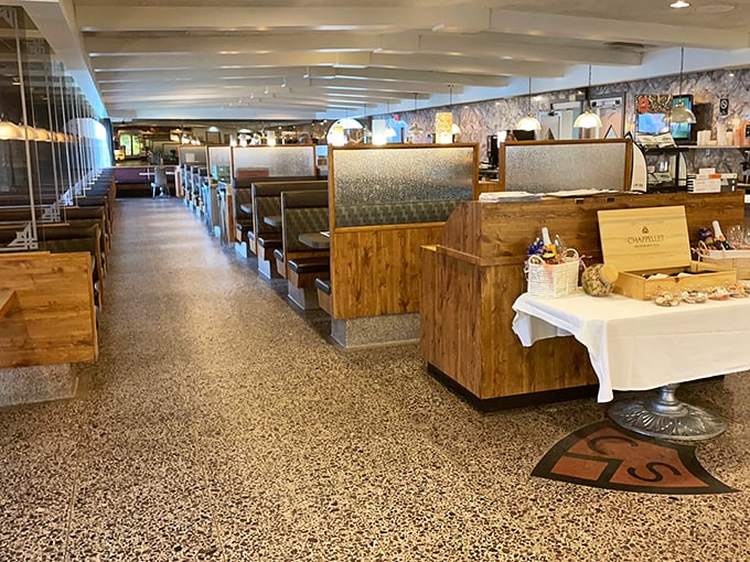 Classic diner geometry at its finest—wooden booths, terrazzo floors, and that unmistakable buzz of conversations that's as essential to the experience as the food itself.