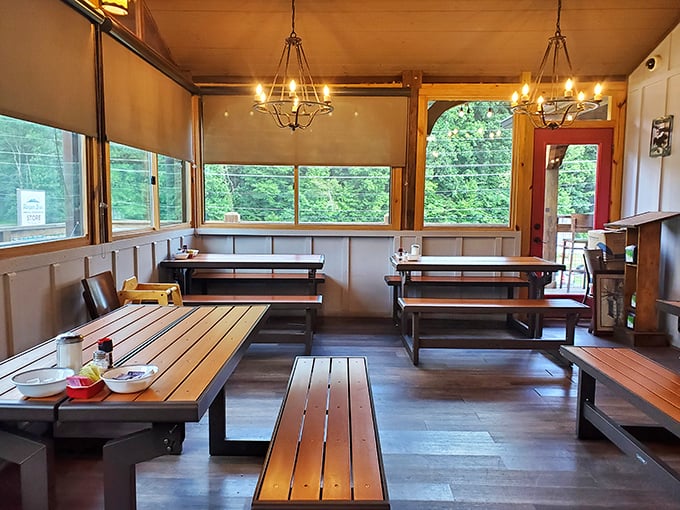 Rustic wooden tables bathed in natural light create the perfect backdrop for mountain meals, while those windows frame the Smokies like living paintings.