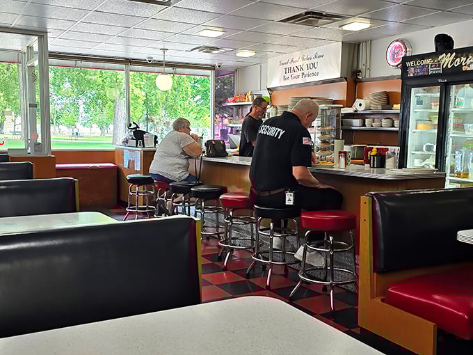 Classic diner counter seating—where strangers become friends and the staff remembers your order before you've even settled onto those spinning red stools.