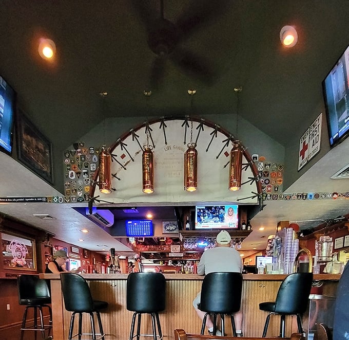 The bar area showcases the firefighter theme with crossed axes and copper beer taps. It's where strangers become friends over wings and cold brews.