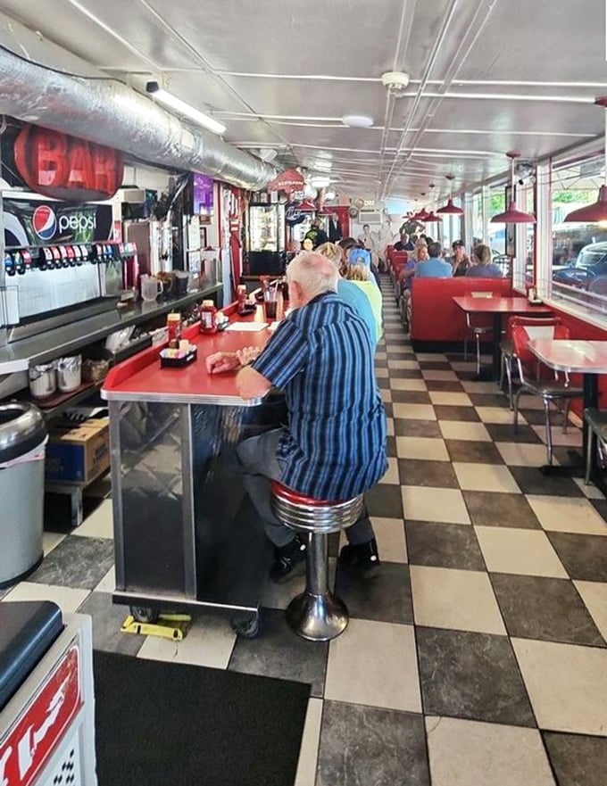 Inside, the checkered floor and counter seating create that perfect nostalgic atmosphere where conversations flow as freely as the coffee.