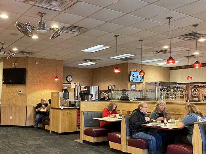 Classic diner ambiance with those signature red pendant lights – where conversations flow as freely as the coffee. The backdrop to countless local stories.
