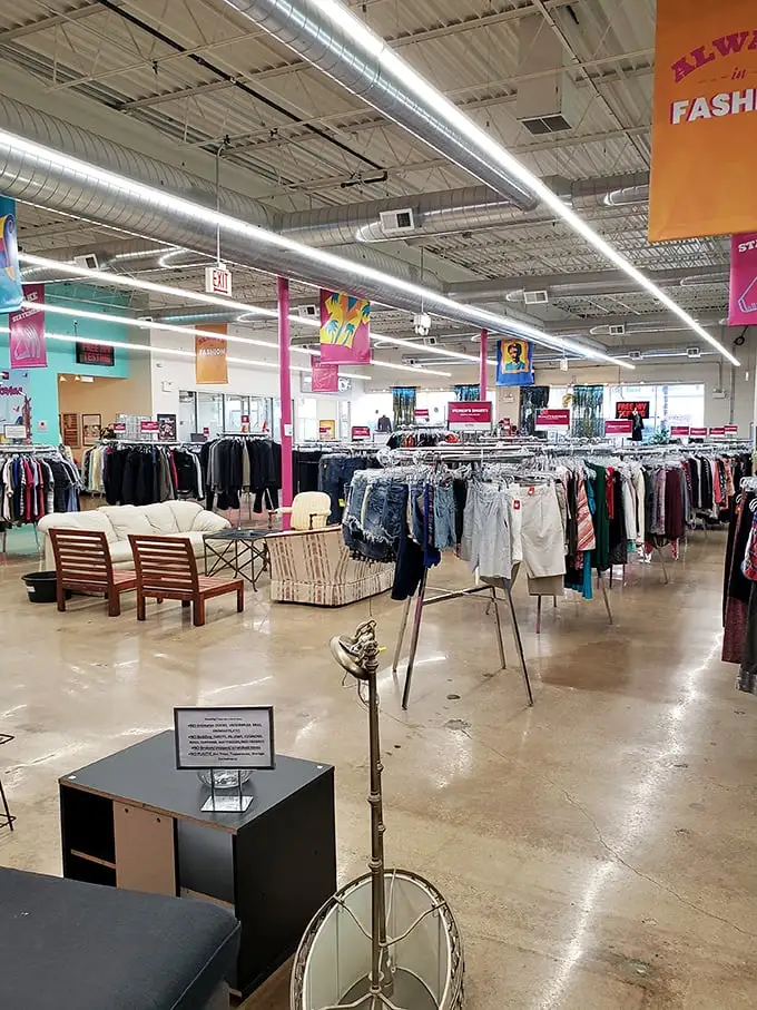 Spacious aisles and organized racks transform thrift shopping from archaeological dig to retail therapy, with colorful banners guiding your treasure hunt.