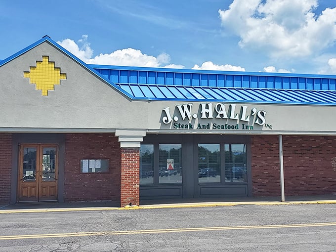 J.W. Hall's Steak and Seafood Inn isn't trying to be trendy—it's too busy being delicious. The blue roof signals comfort food territory ahead.