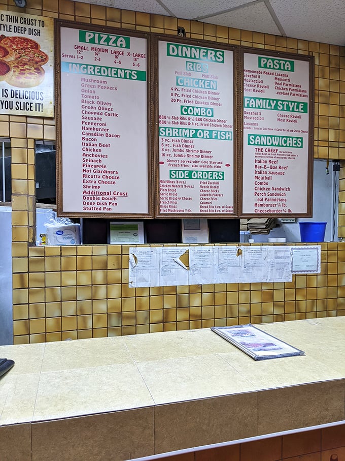 The menu wall—a yellow-tiled monument to possibility where indecision isn't a bug, it's a feature.